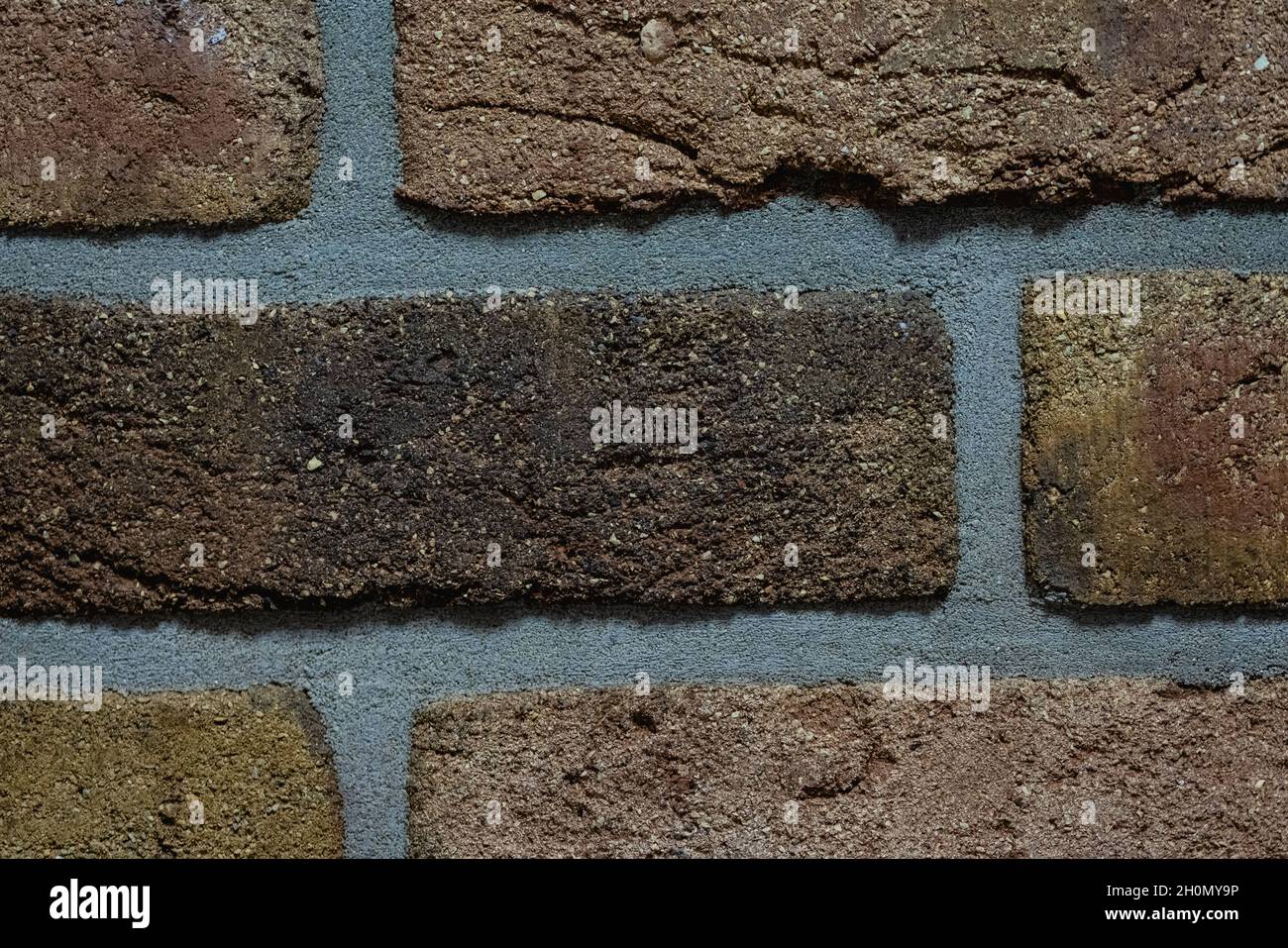 Close-up texture of a brown scratched brick wall with a gray seam Stock ...