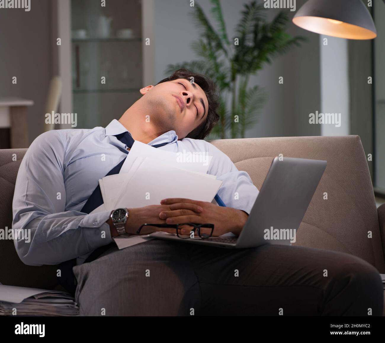 The businessman workaholic working late at home Stock Photo - Alamy