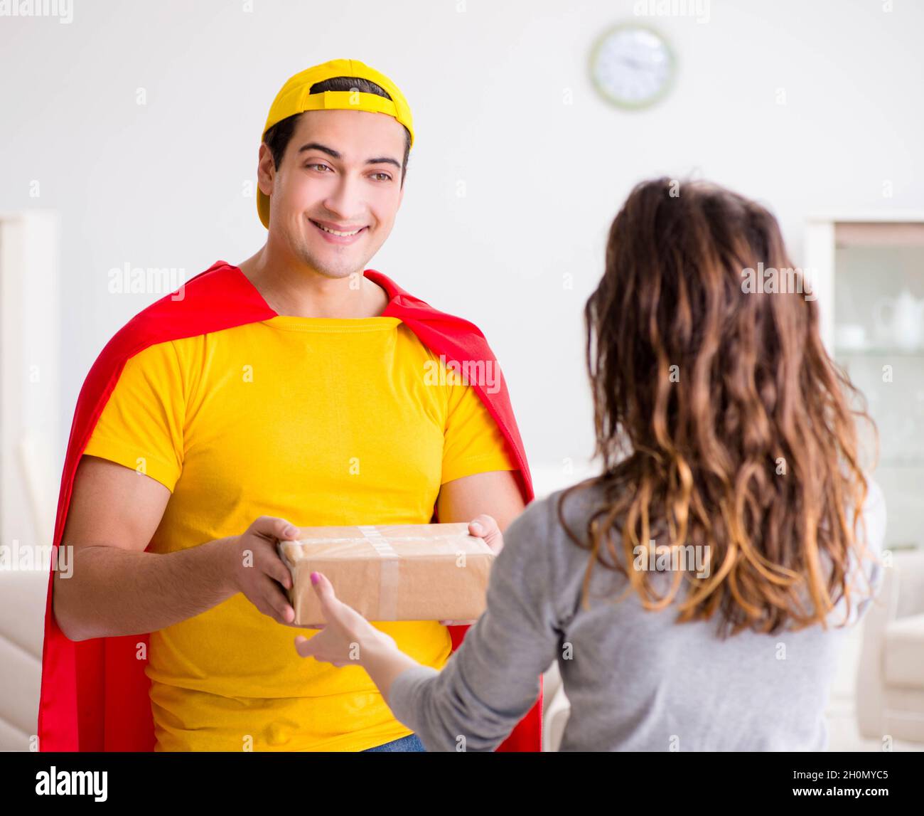 The superhero delivery guy with box Stock Photo - Alamy