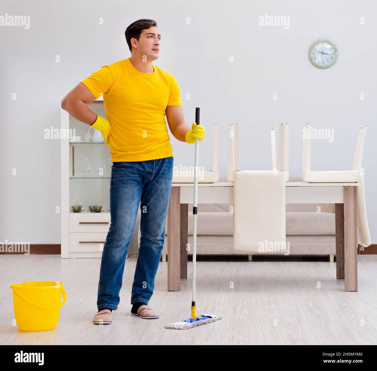 The man cleaning the house helping his wife Stock Photo - Alamy