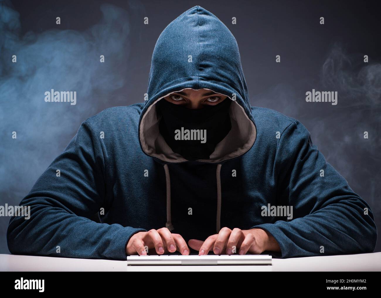 The computer hacker working in dark room Stock Photo - Alamy