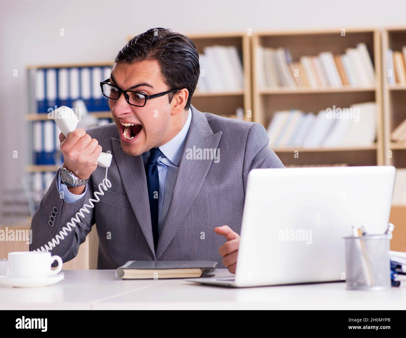 The angry businessman working in the office Stock Photo - Alamy