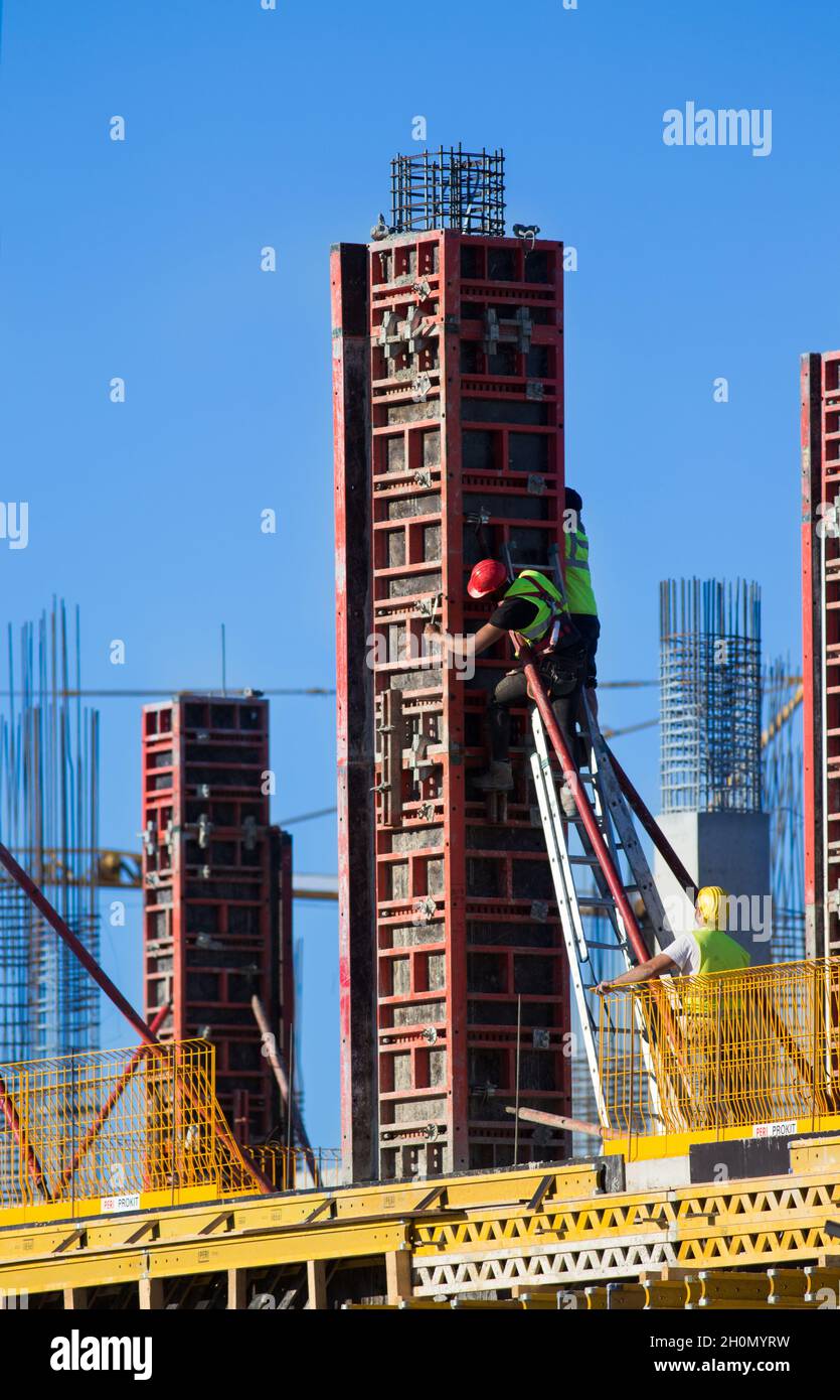 Construction workers assembling formworks for concrete column at ...