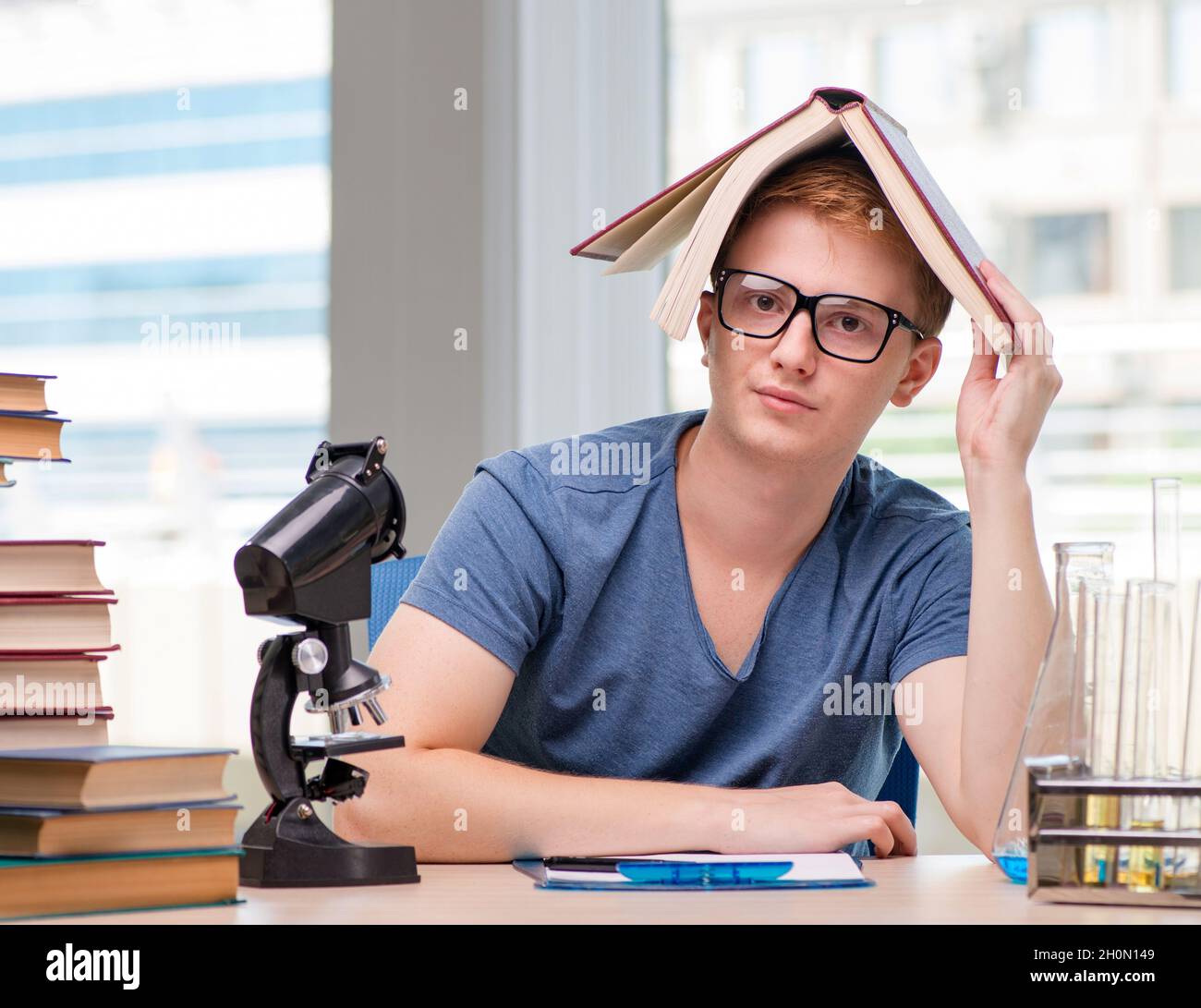 The young student tired and exhausted preparing for chemistry exam ...