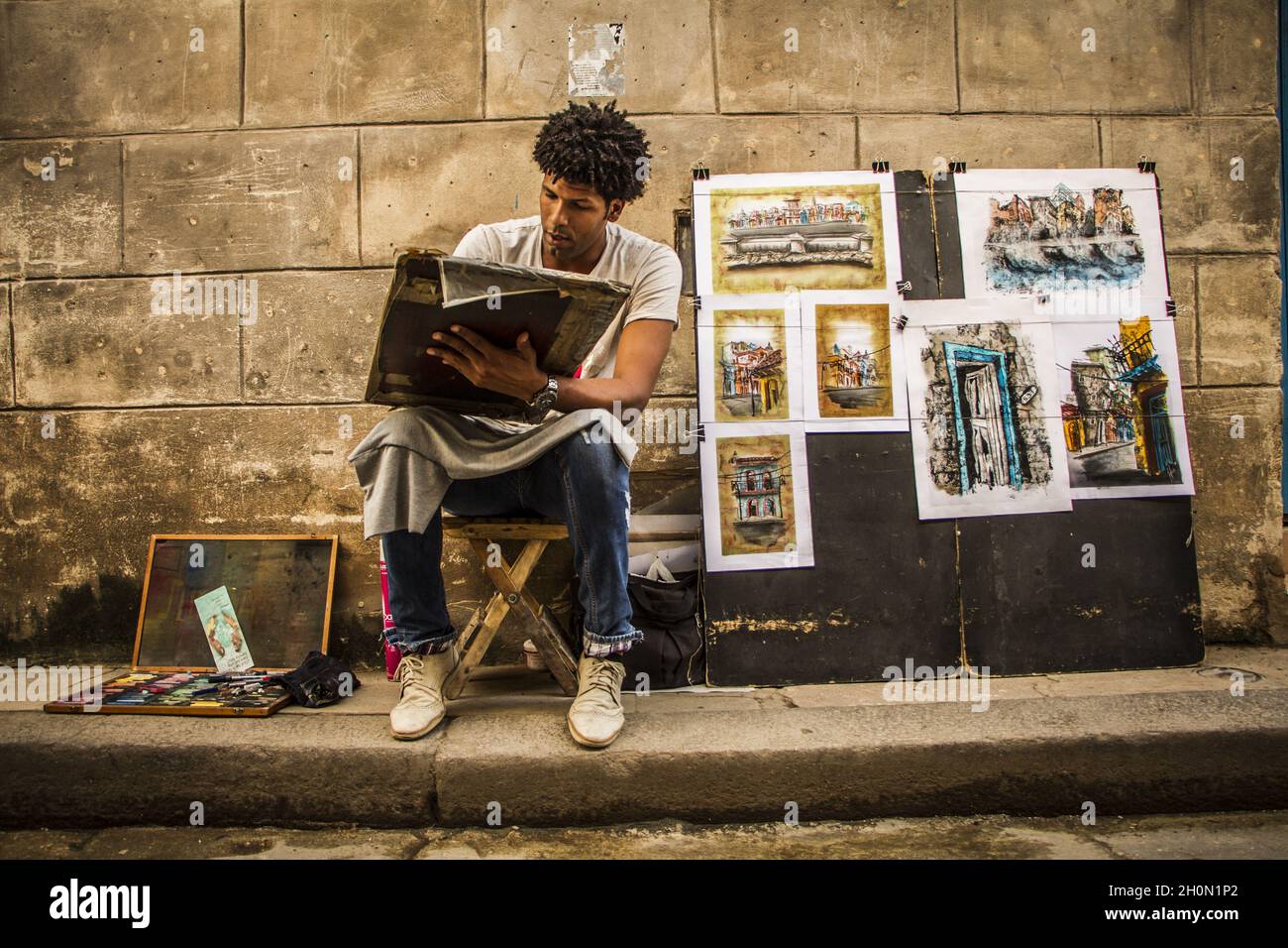 HABANA, CUBA - Dec 12, 2016: A street artist painting in the streets of ...