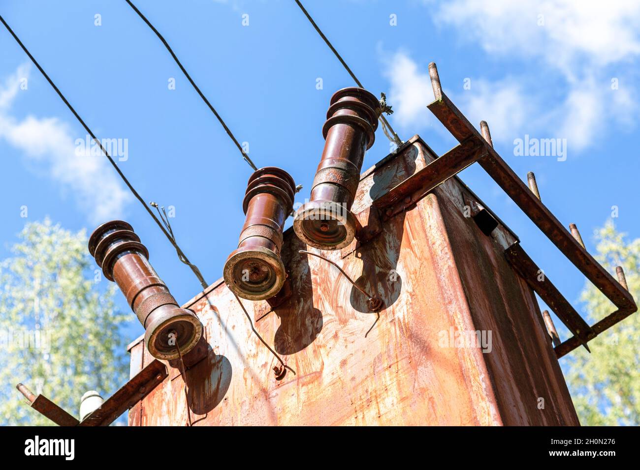 Old voltage power transformer substation at the countryside in summer ...