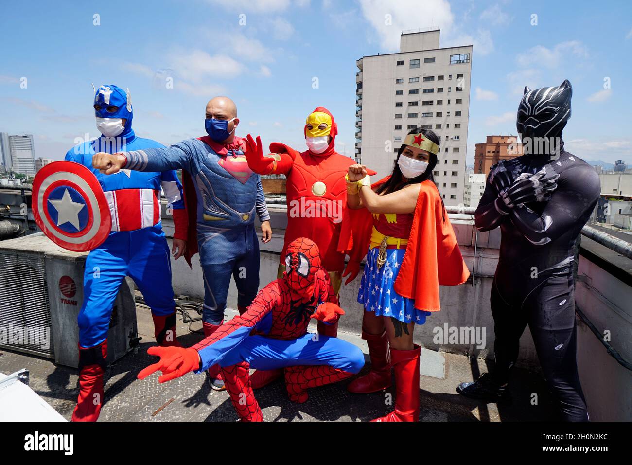 October 12, 2021: Window cleaners wearing superhero costumes greet a ...