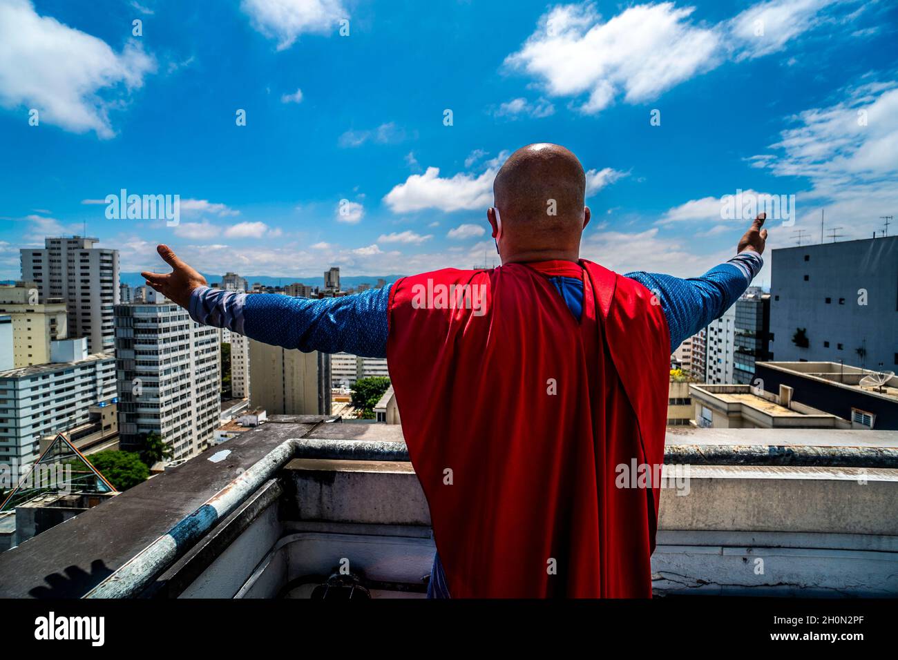 October 12, 2021: Window cleaners wearing superhero costumes greet a ...