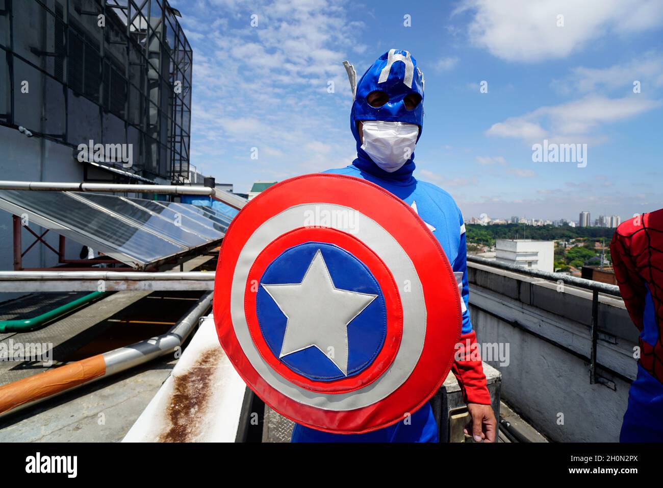 October 12, 2021: Window cleaners wearing superhero costumes greet a ...