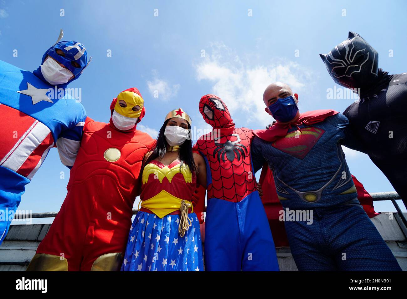 October 12, 2021: Window cleaners wearing superhero costumes greet a ...