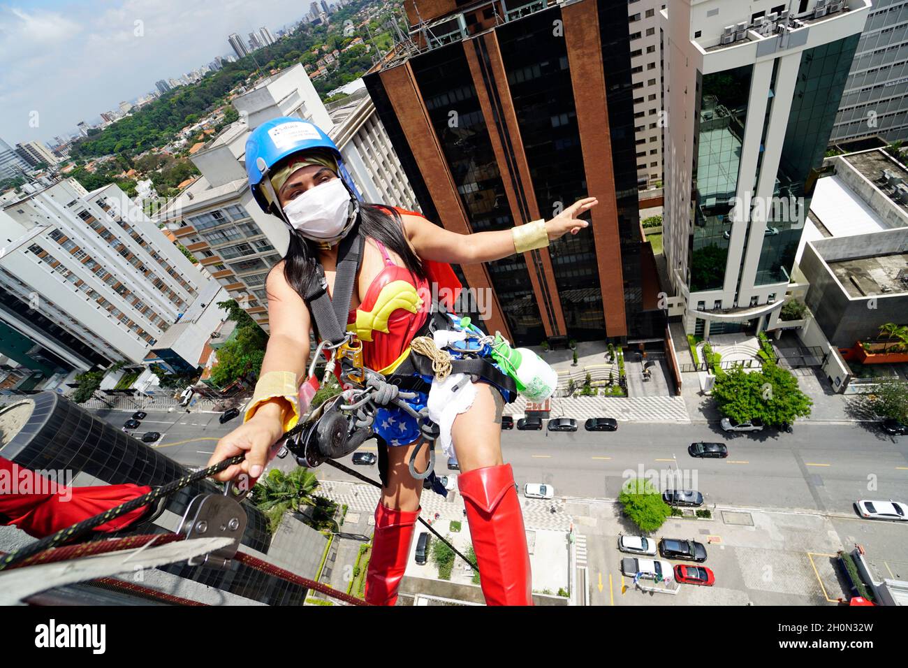 October 12, 2021: Window cleaners wearing superhero costumes greet a ...