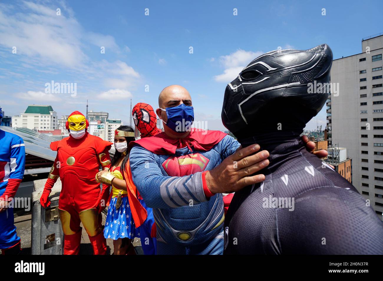 October 12, 2021: Window cleaners wearing superhero costumes greet a ...