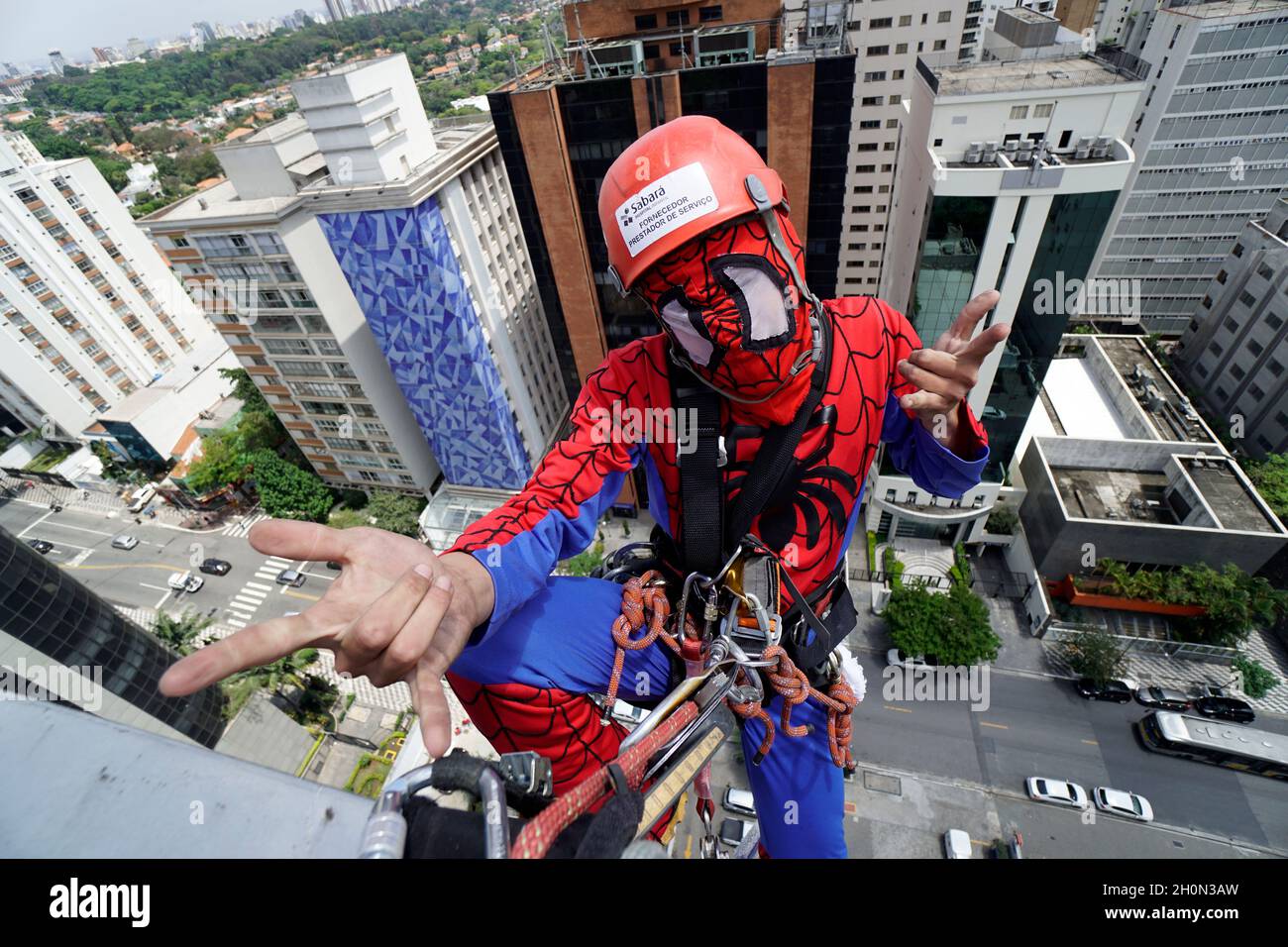 October 12, 2021: Window cleaners wearing superhero costumes greet a ...