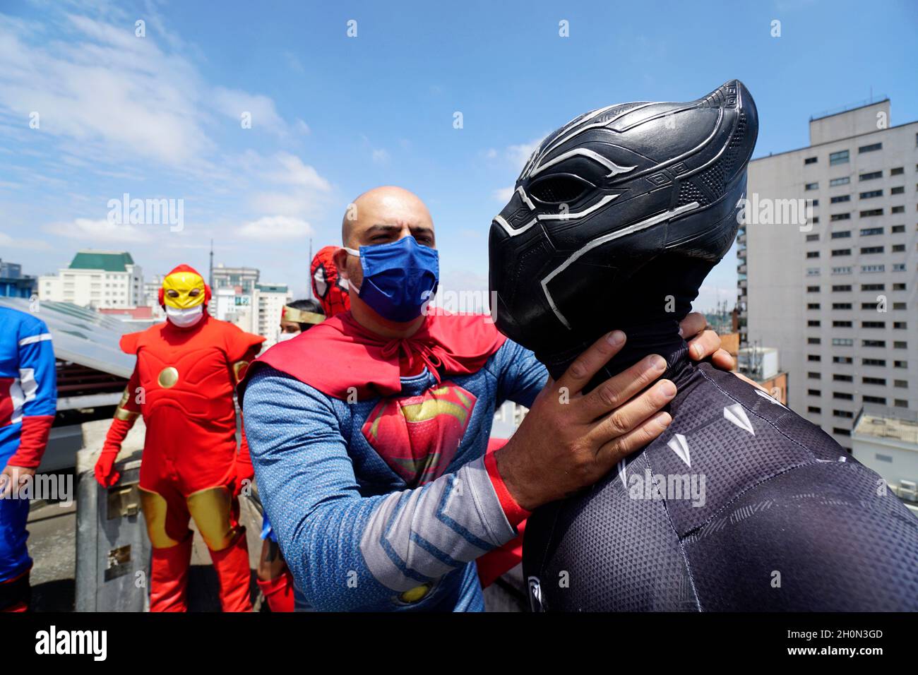 October 12, 2021: Window cleaners wearing superhero costumes greet a ...