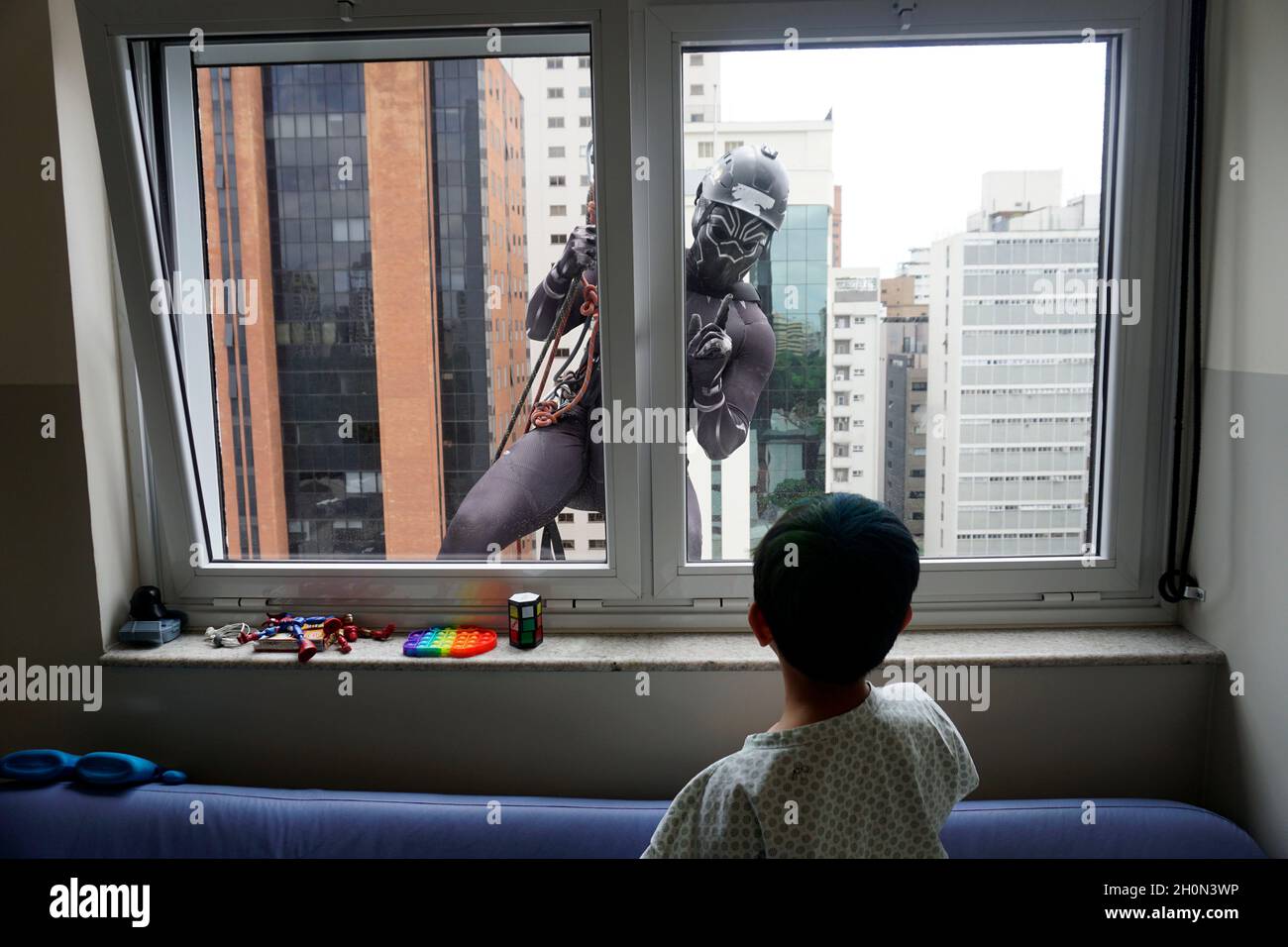 October 12, 2021: Window cleaners wearing superhero costumes greet a ...