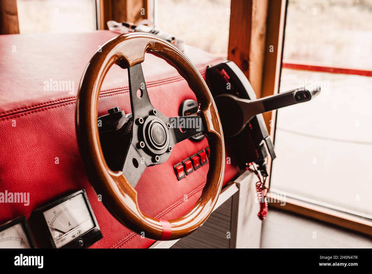 Steering wheel and boat controls - wood trim Stock Photo - Alamy