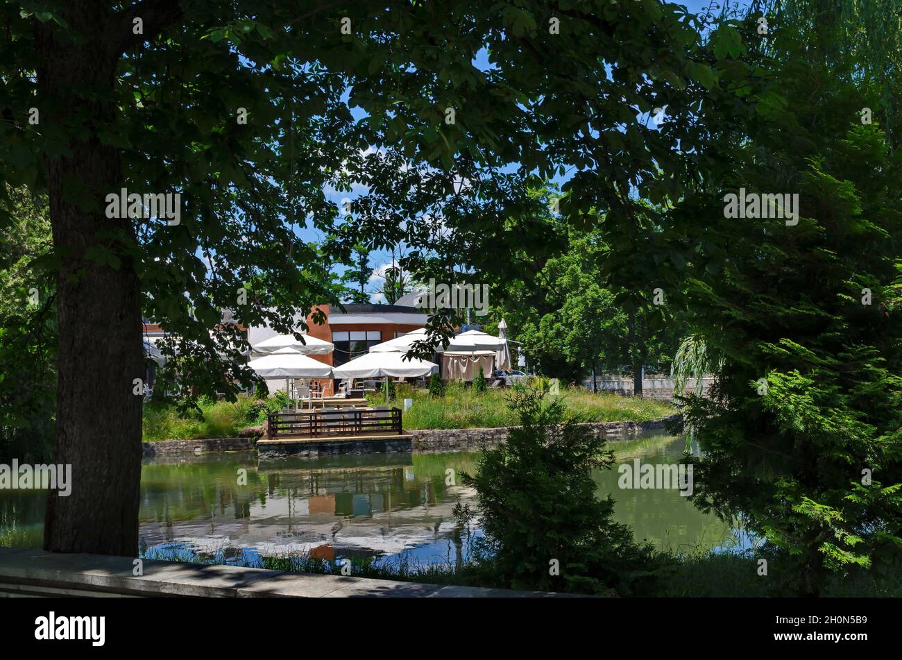 View of a cosy relaxation area under awnings with tables and chairs on ...