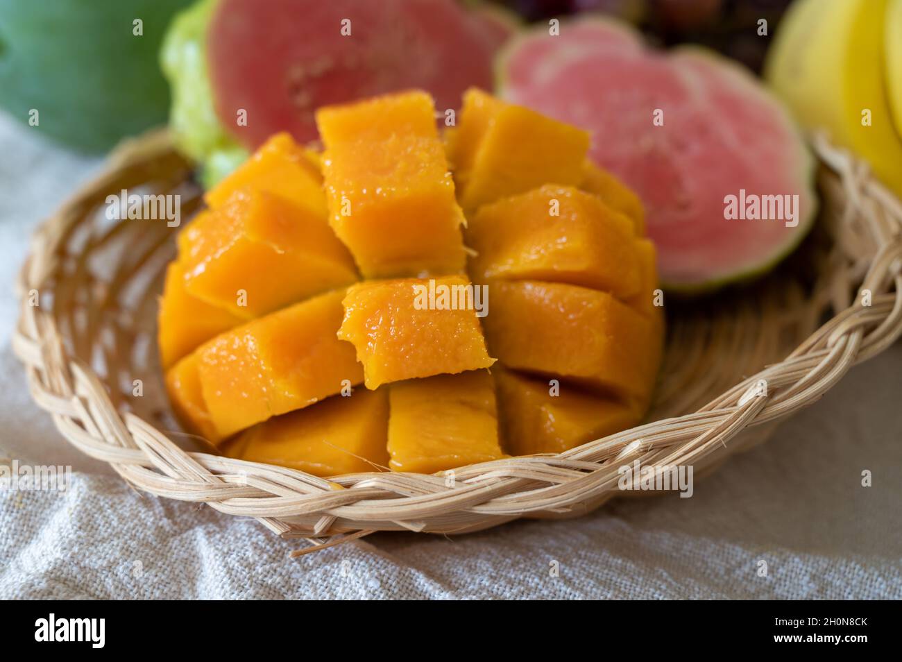 Exotic fruits of Cyprus, fresh yellow juicy mango, ripe pink guava ...