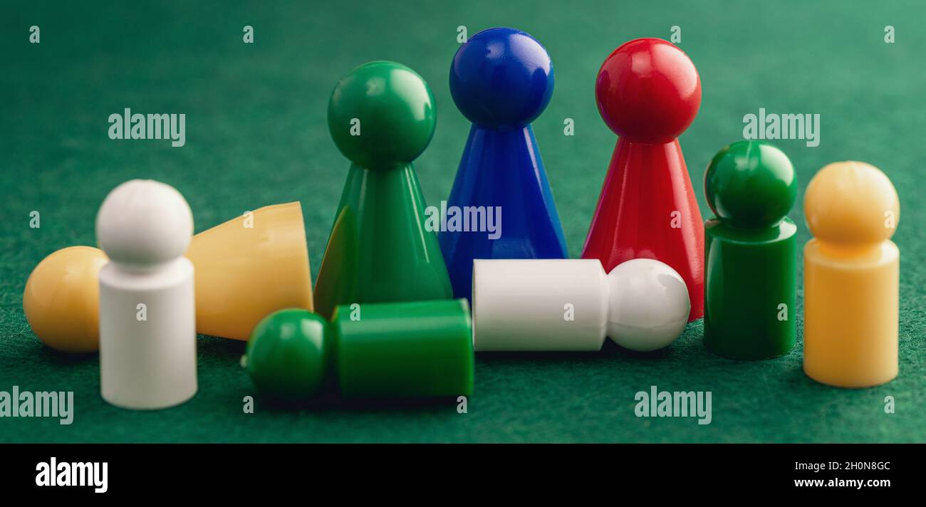Colored board game figures with dice. Board games concept Stock Photo ...