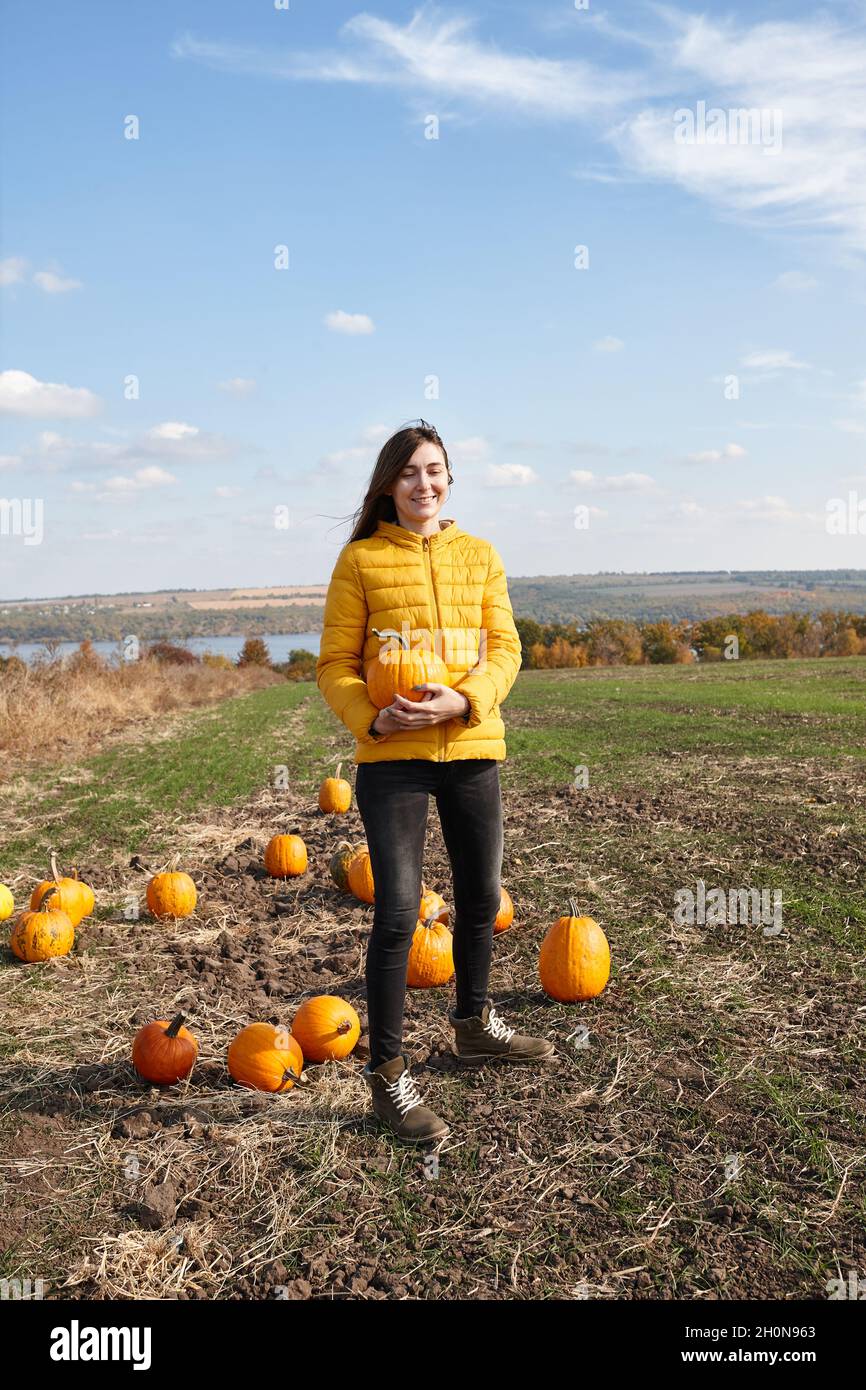 Woman in Halloween pumpkin patch field in sunny day Stock Photo - Alamy