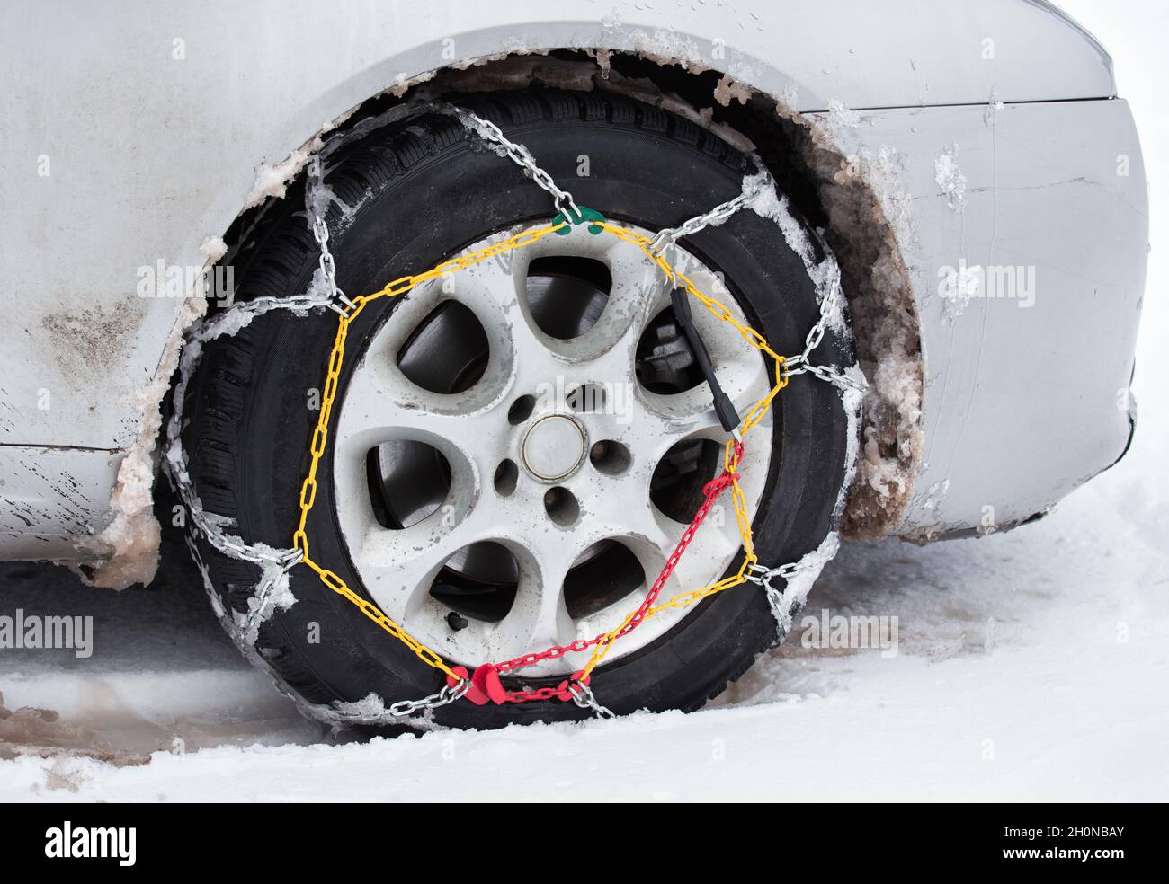 Front view of tire chains on car wheel on dirty vehicle in snow Stock ...