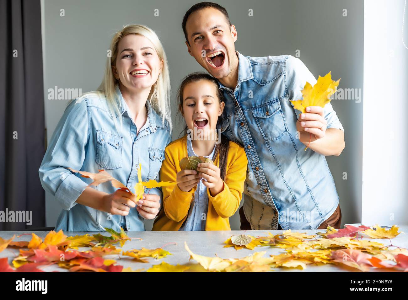 Portrait of family during the autumn Stock Photo - Alamy