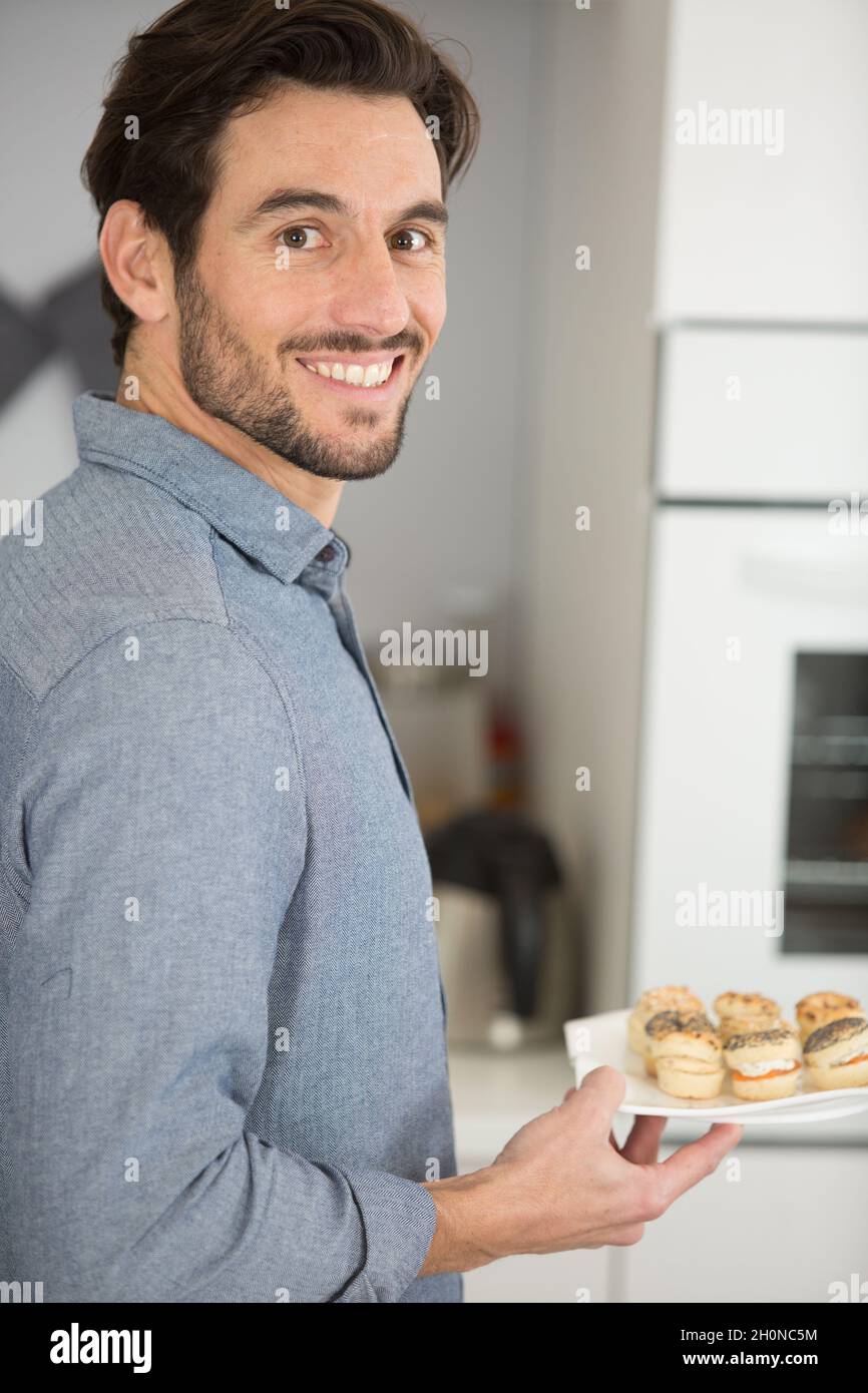 man holding a tapas dish Stock Photo - Alamy