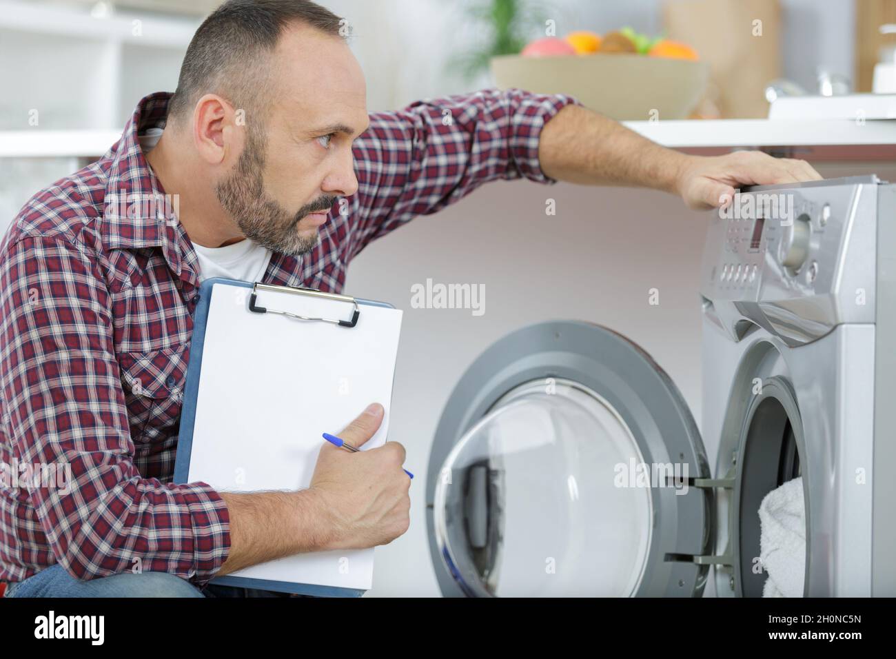 Man near washing machine hi-res stock photography and images - Alamy