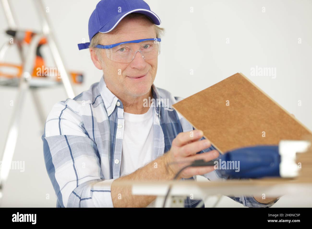 Mature man repairing furniture hi-res stock photography and images - Alamy