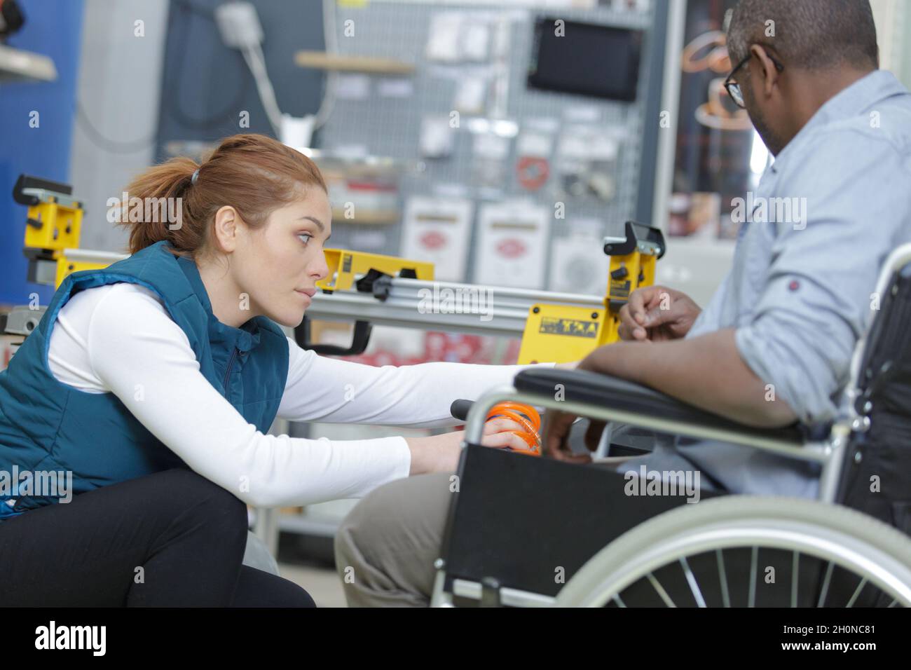 man in wheelchair shopping in hardware store Stock Photo - Alamy