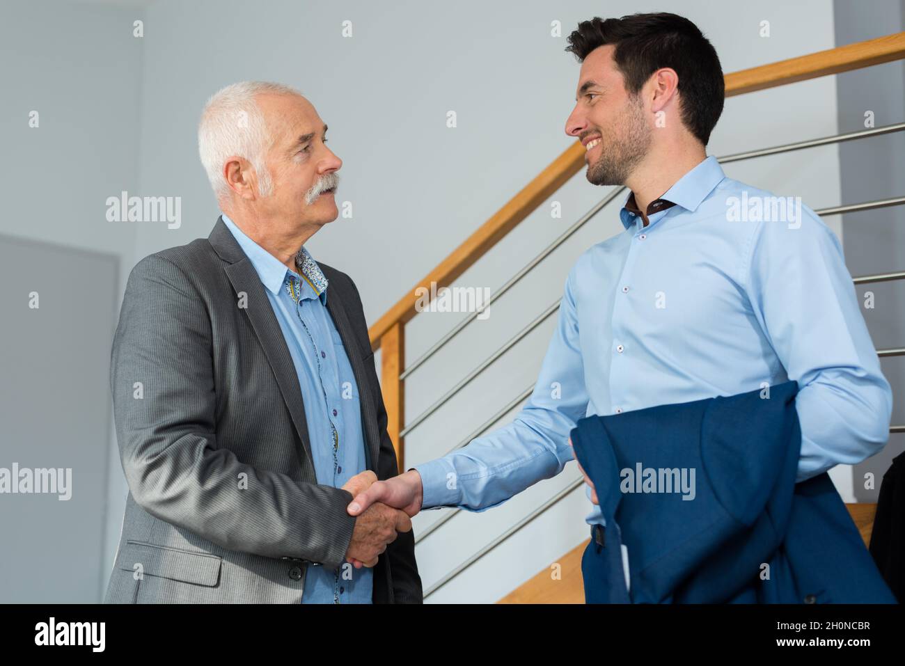 senior man shaking hands with businessman Stock Photo - Alamy