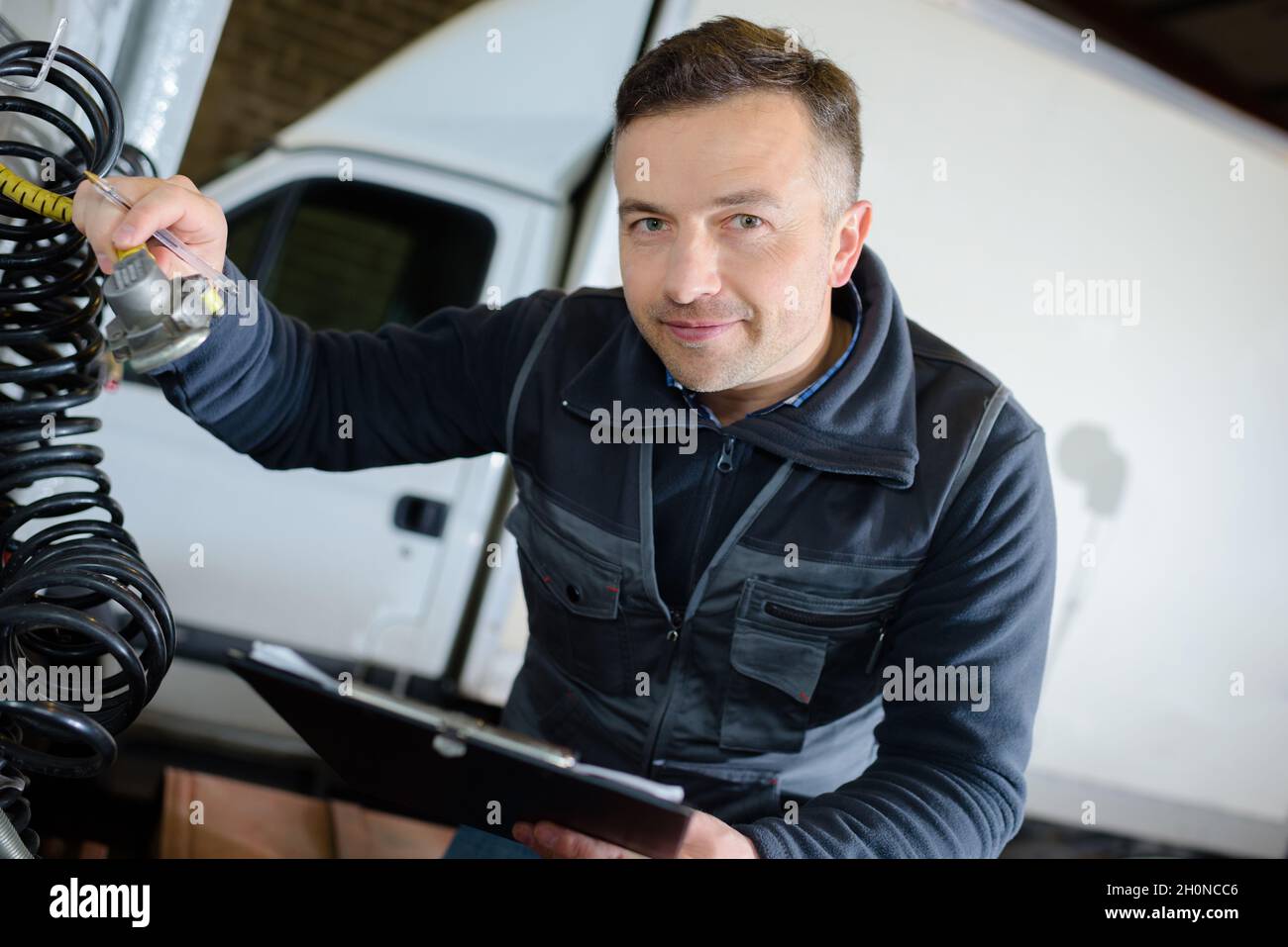 warehouse worker driver in uniform in front of delivery truck Stock ...