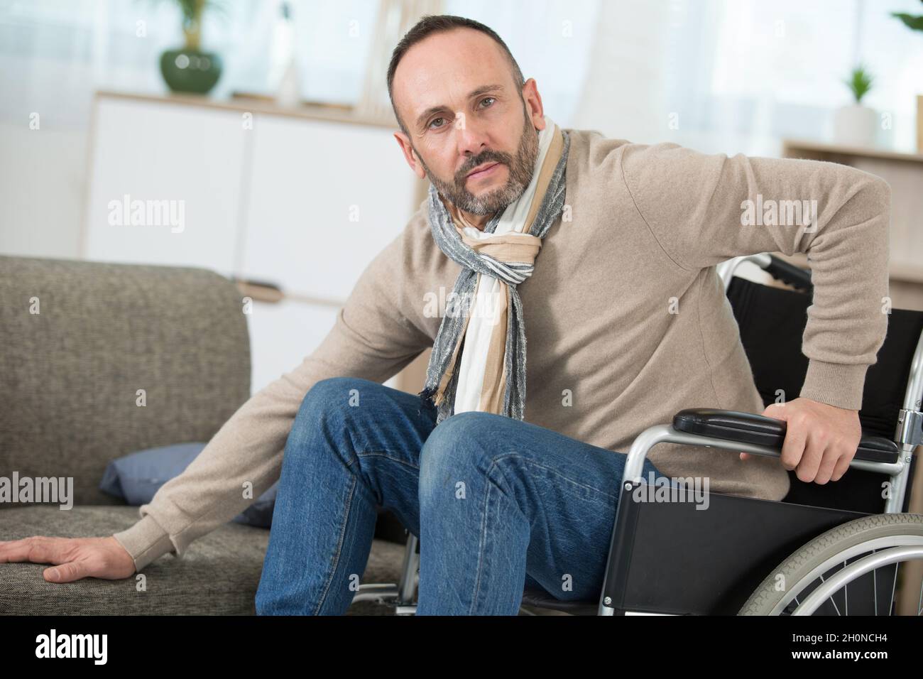 disable man trying to replace himself on sofa Stock Photo - Alamy