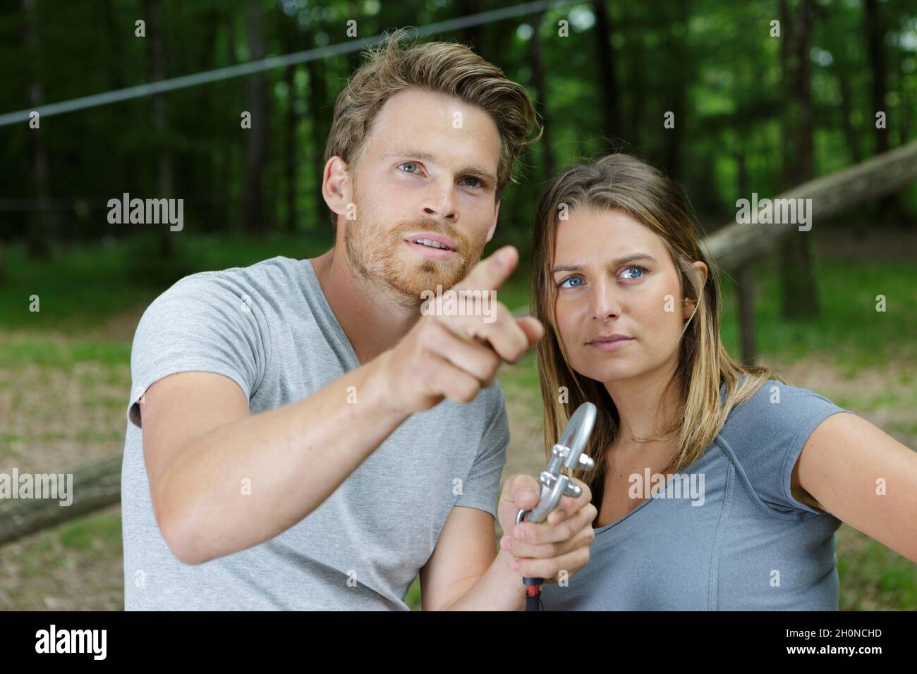 a young couple pointing at something Stock Photo - Alamy