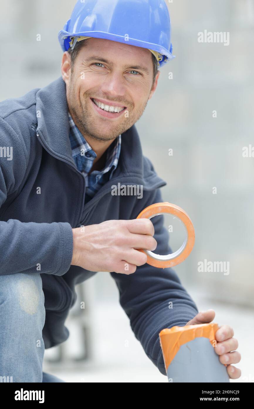engineer with safety vest and helmet looking at camera Stock Photo - Alamy