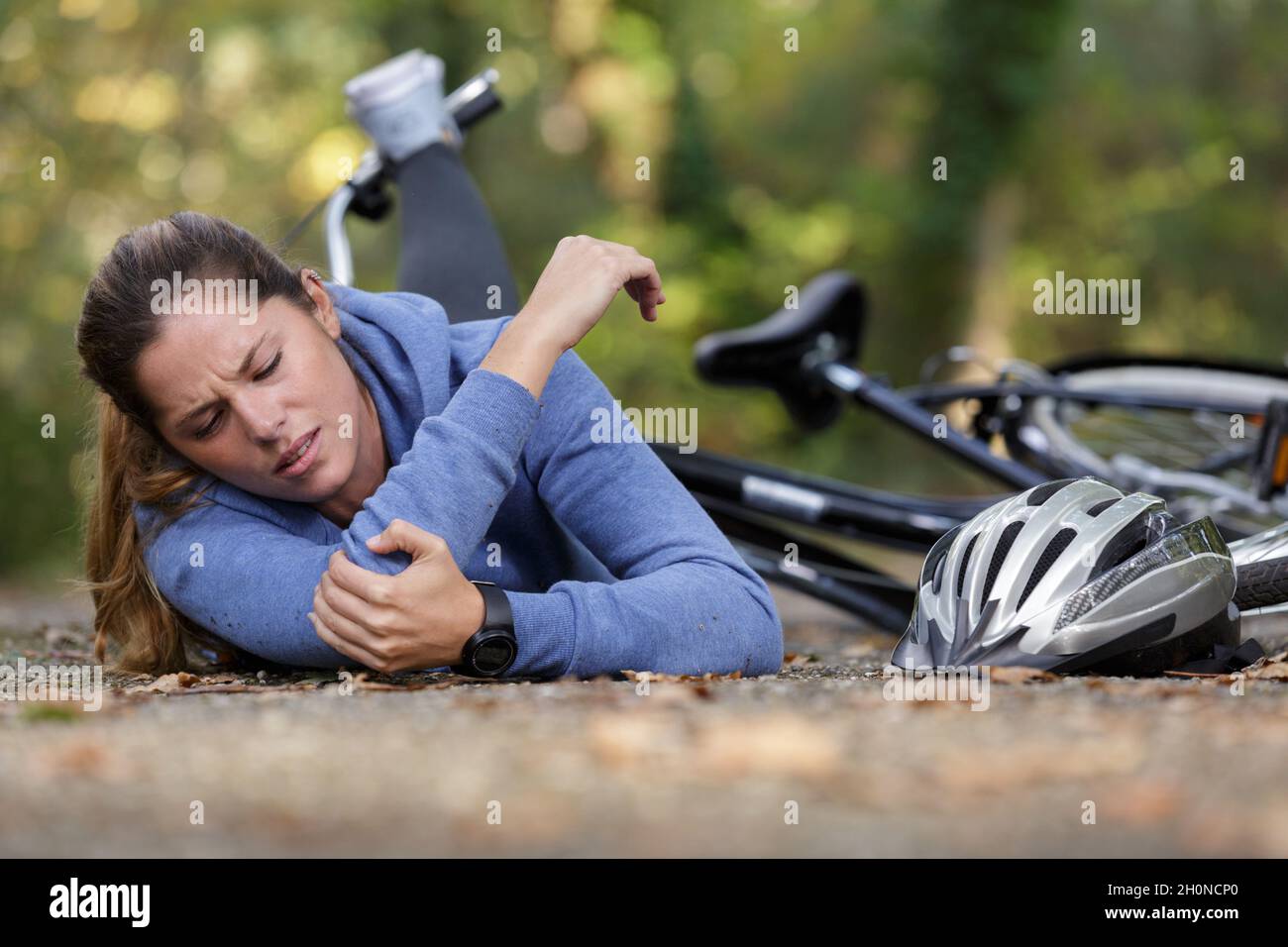 oung woman cyclist fell off road bike Stock Photo - Alamy