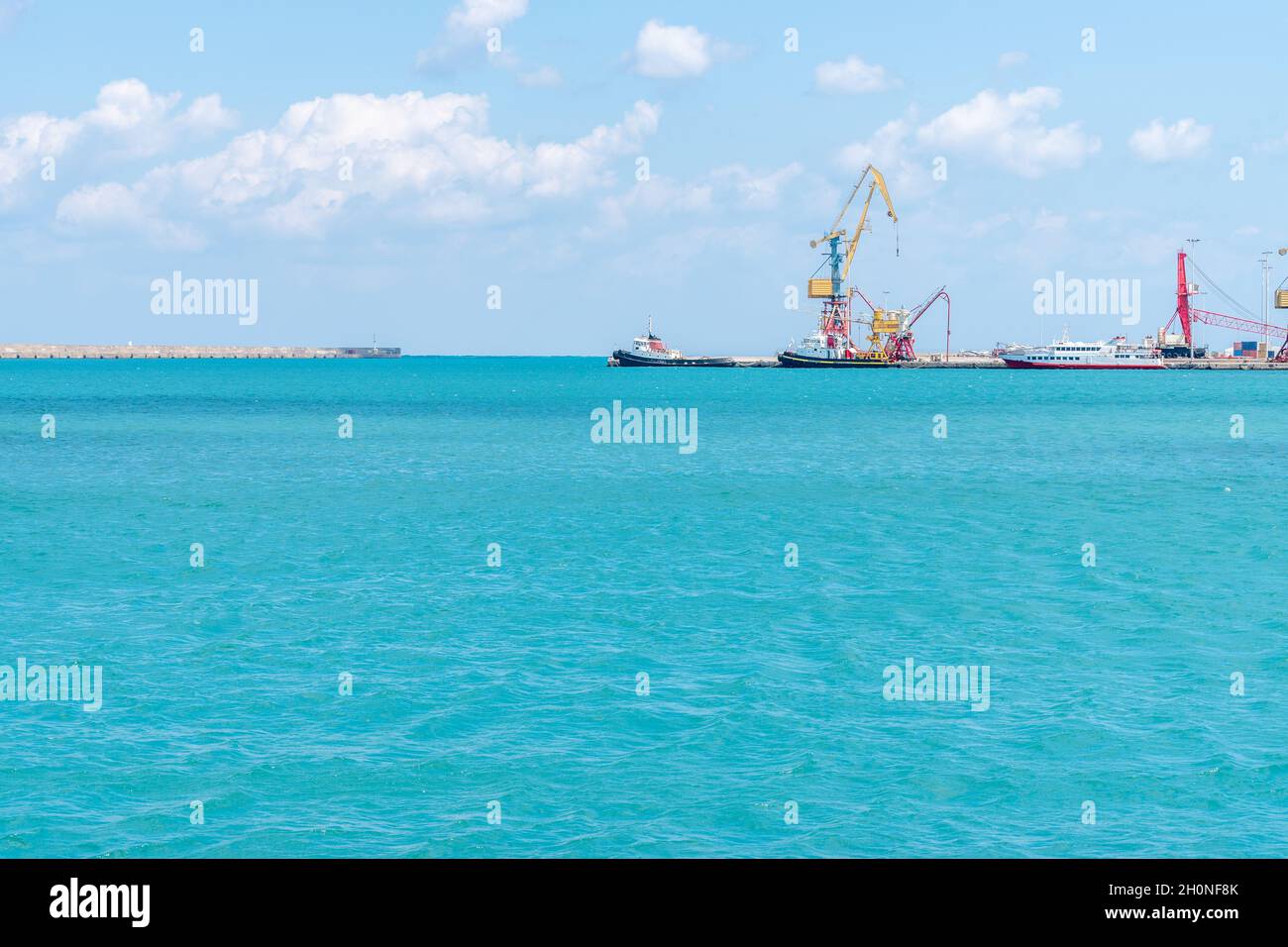 Boats in the seaport on the background cranes and containers Stock ...