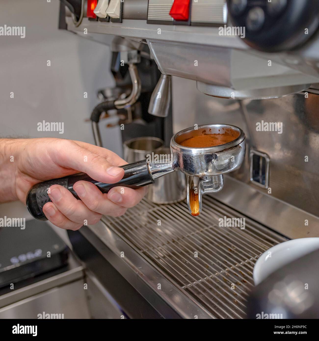 Making coffee on a professional coffee machine in a coffee shop. Holder ...
