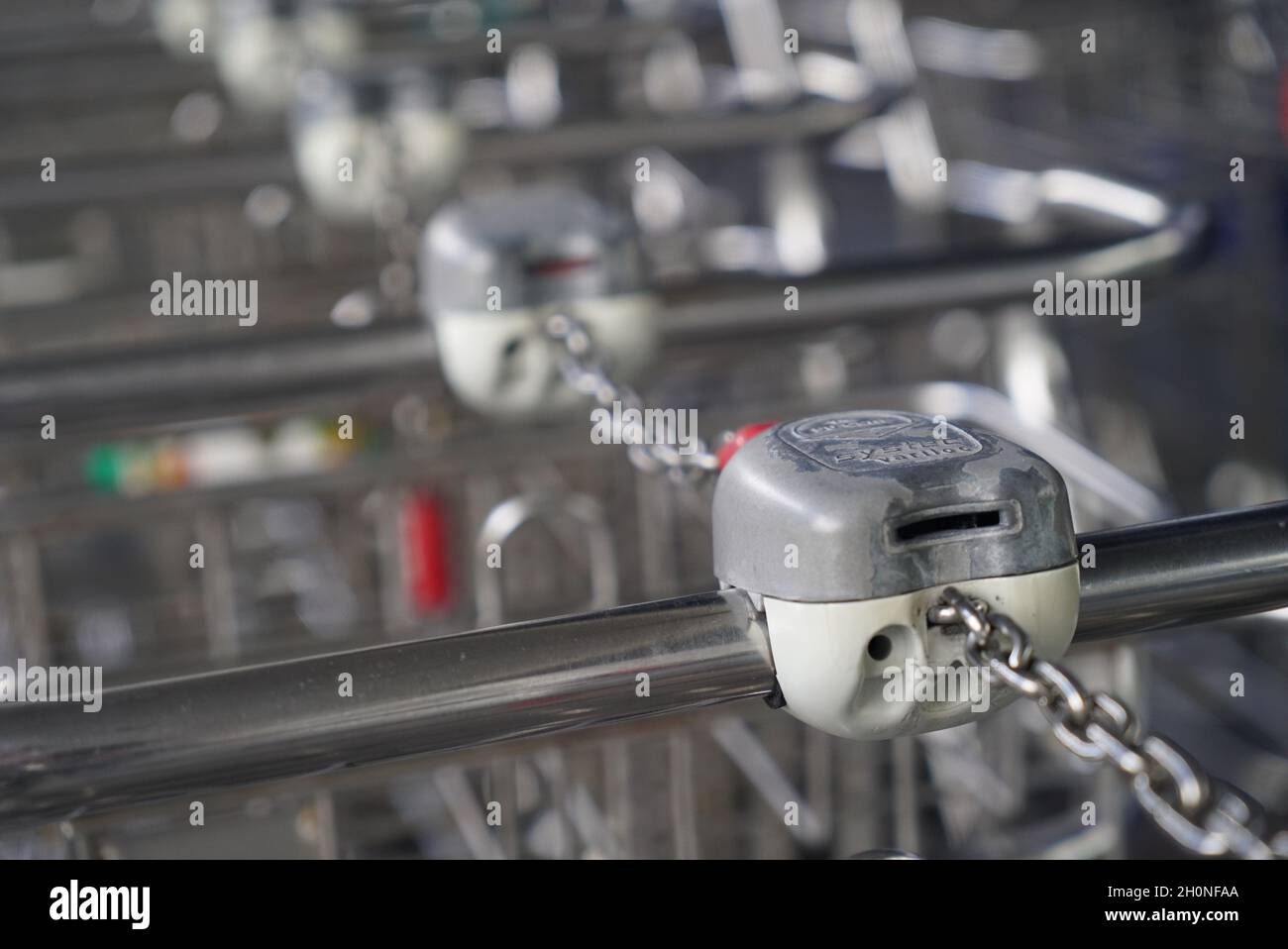 Selective focus shot of supermarket shopping carts chained together ...