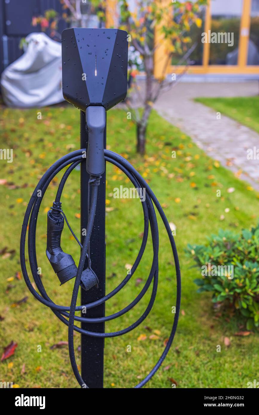 Close up view of charging station for electric car in front yard of ...