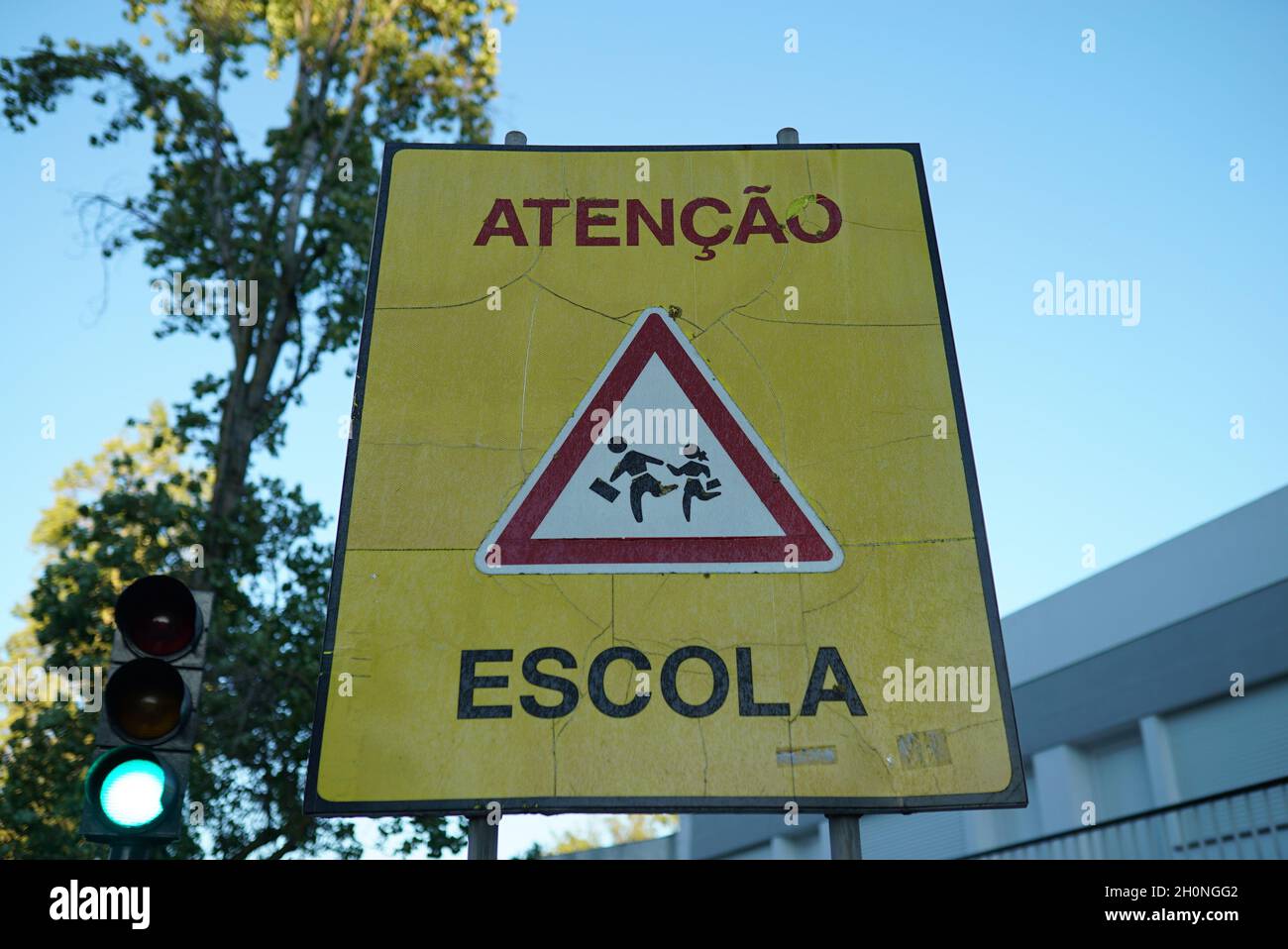 Low angle shot of a warning sign with a writing 'attention school' in ...