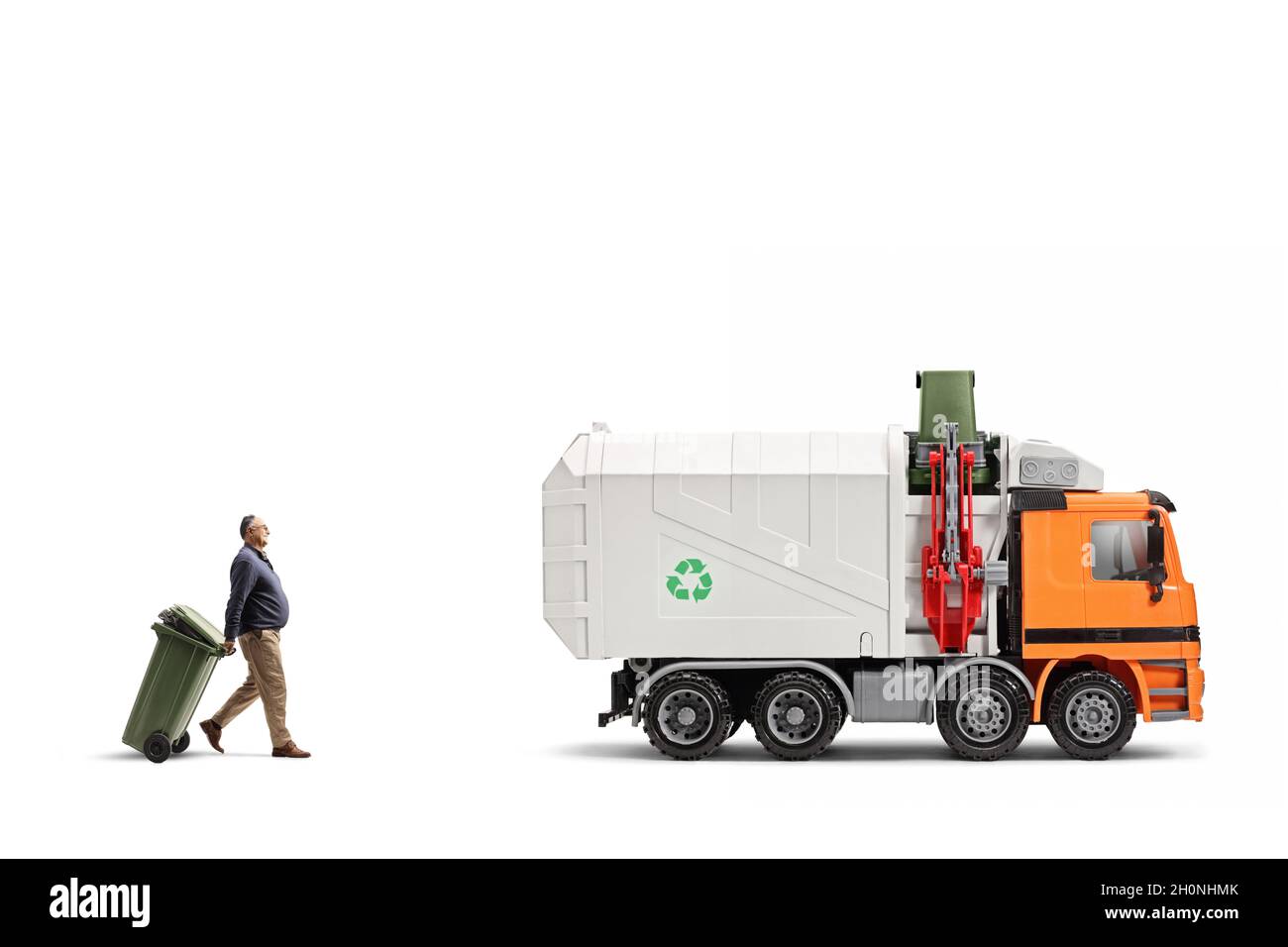 Full length profile shot of a mature man pulling a plastic waste bin ...