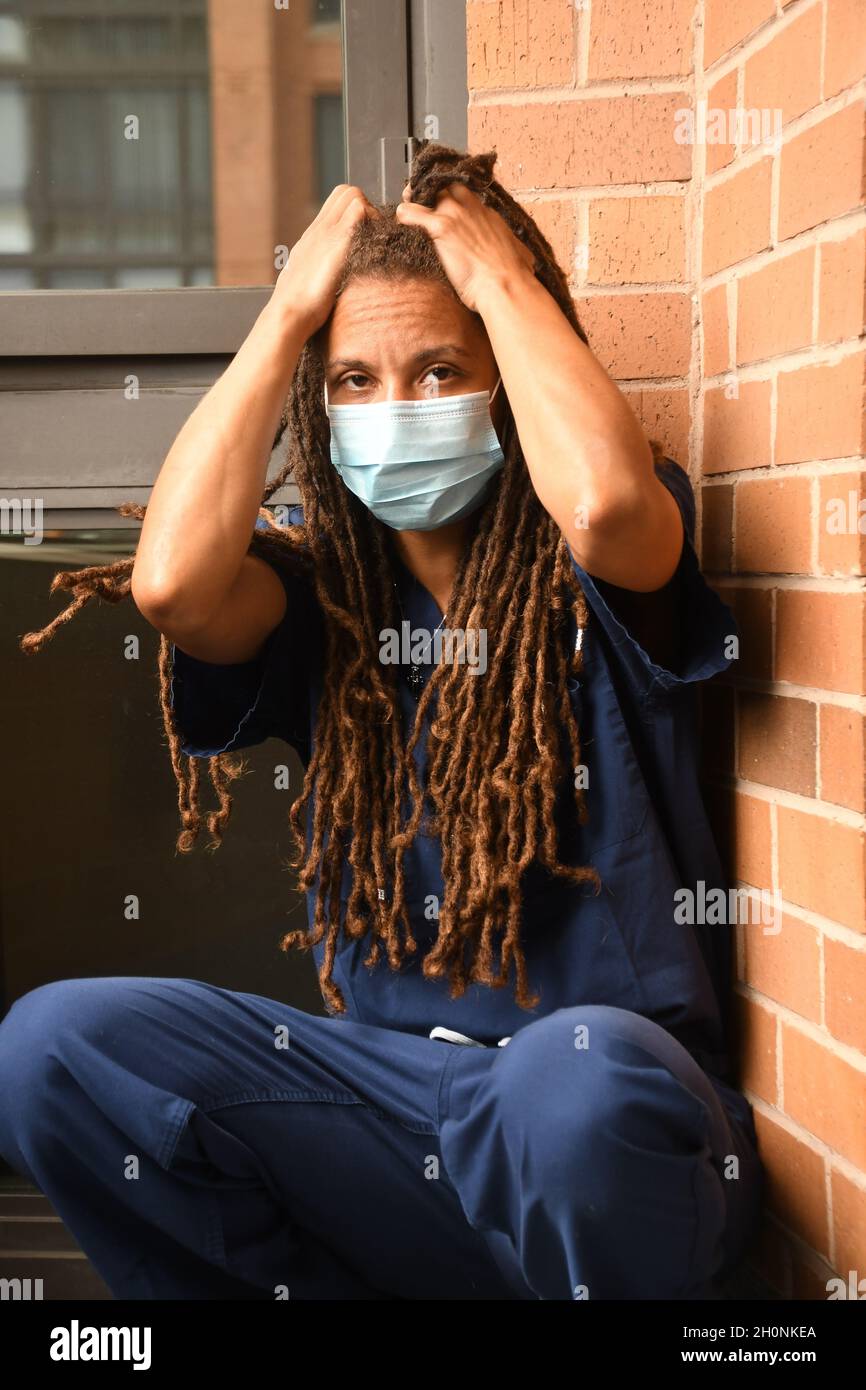 Worn out female doctor on the frontline during the Covid-19 global ...