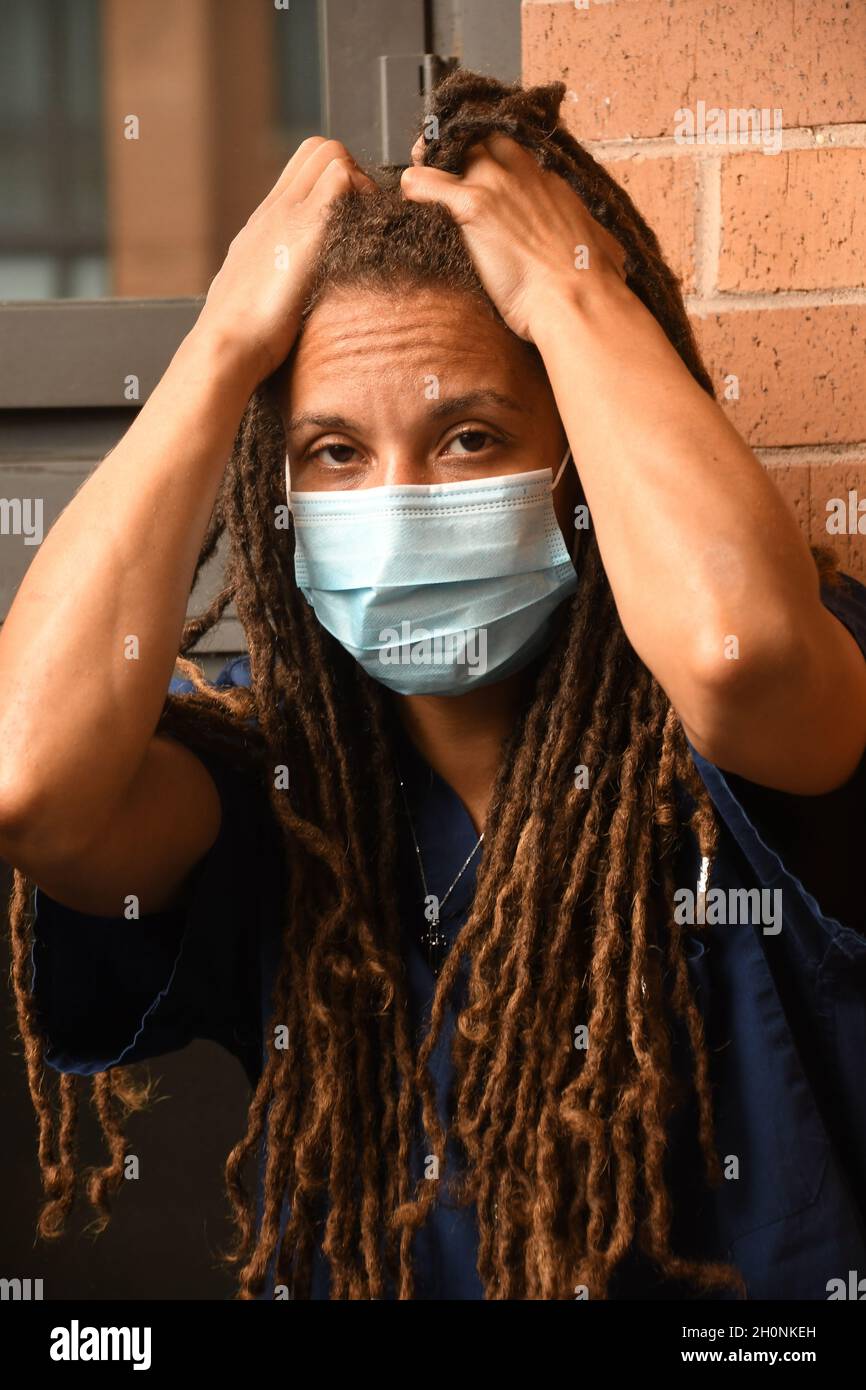 Worn out female doctor on the frontline during the Covid-19 global ...