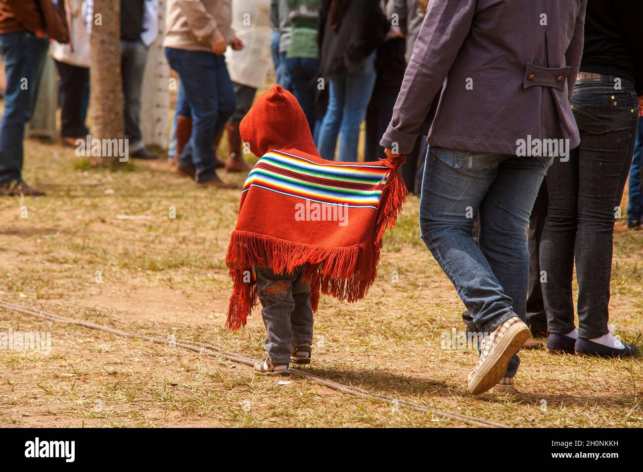 A small boy wearing a traditional poncho at an rodeo, Bonito, Mato ...