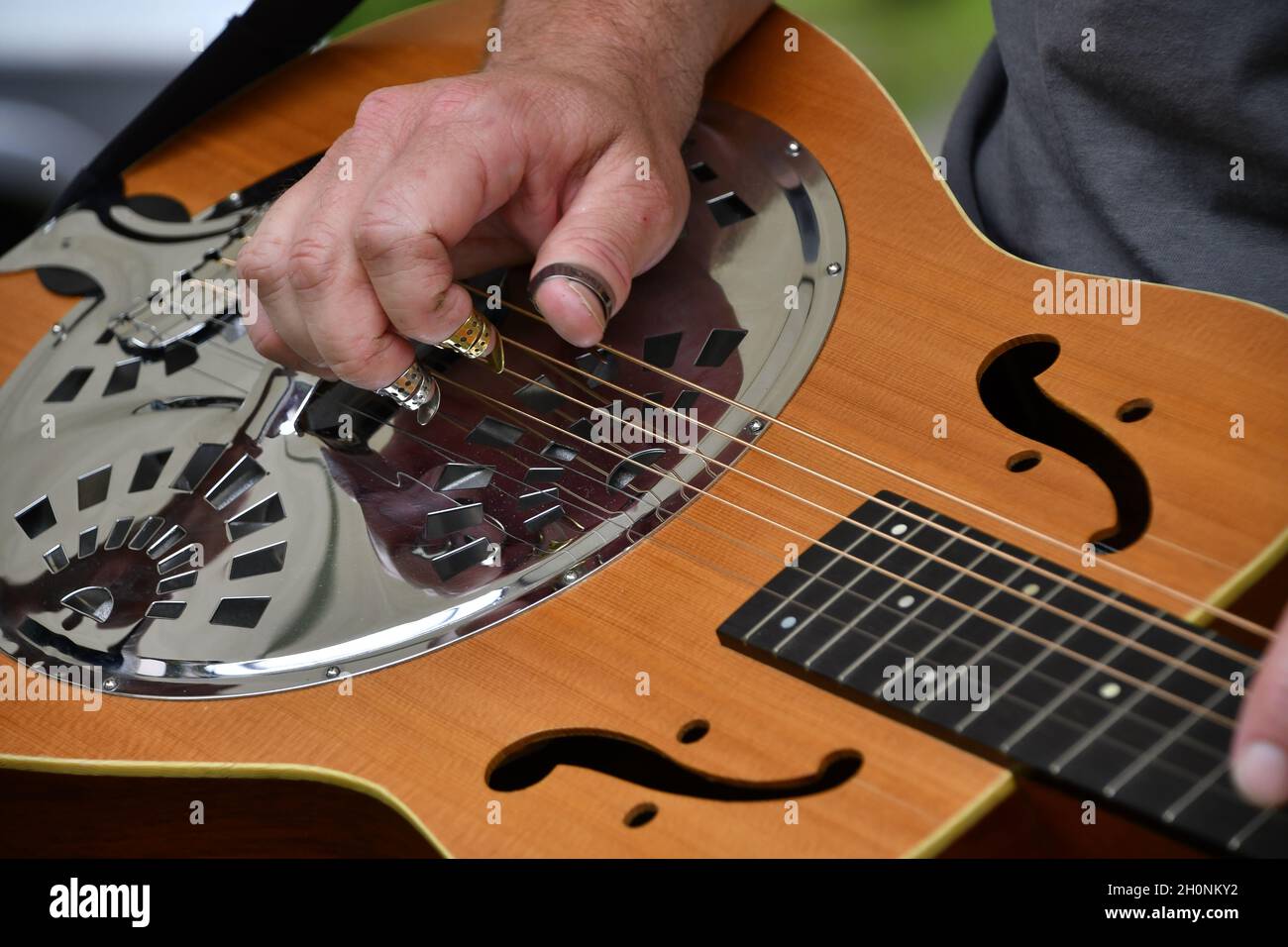 Male hand plays the Dobro for bluegrass music Stock Photo - Alamy