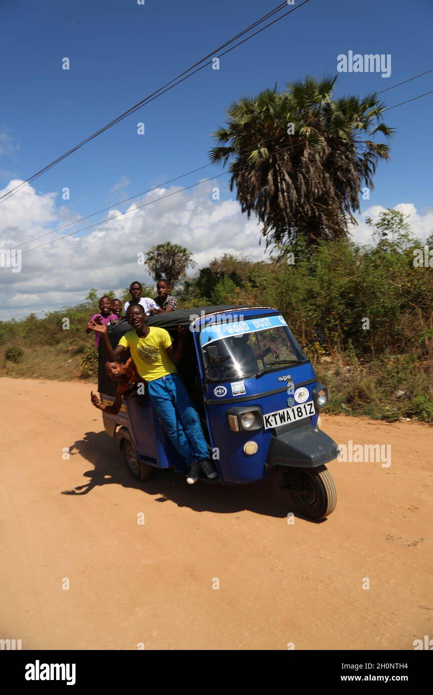 UKUNDA, KENYA - Dec 08, 2016: A view of a people riding a tuk-tuk on a ...
