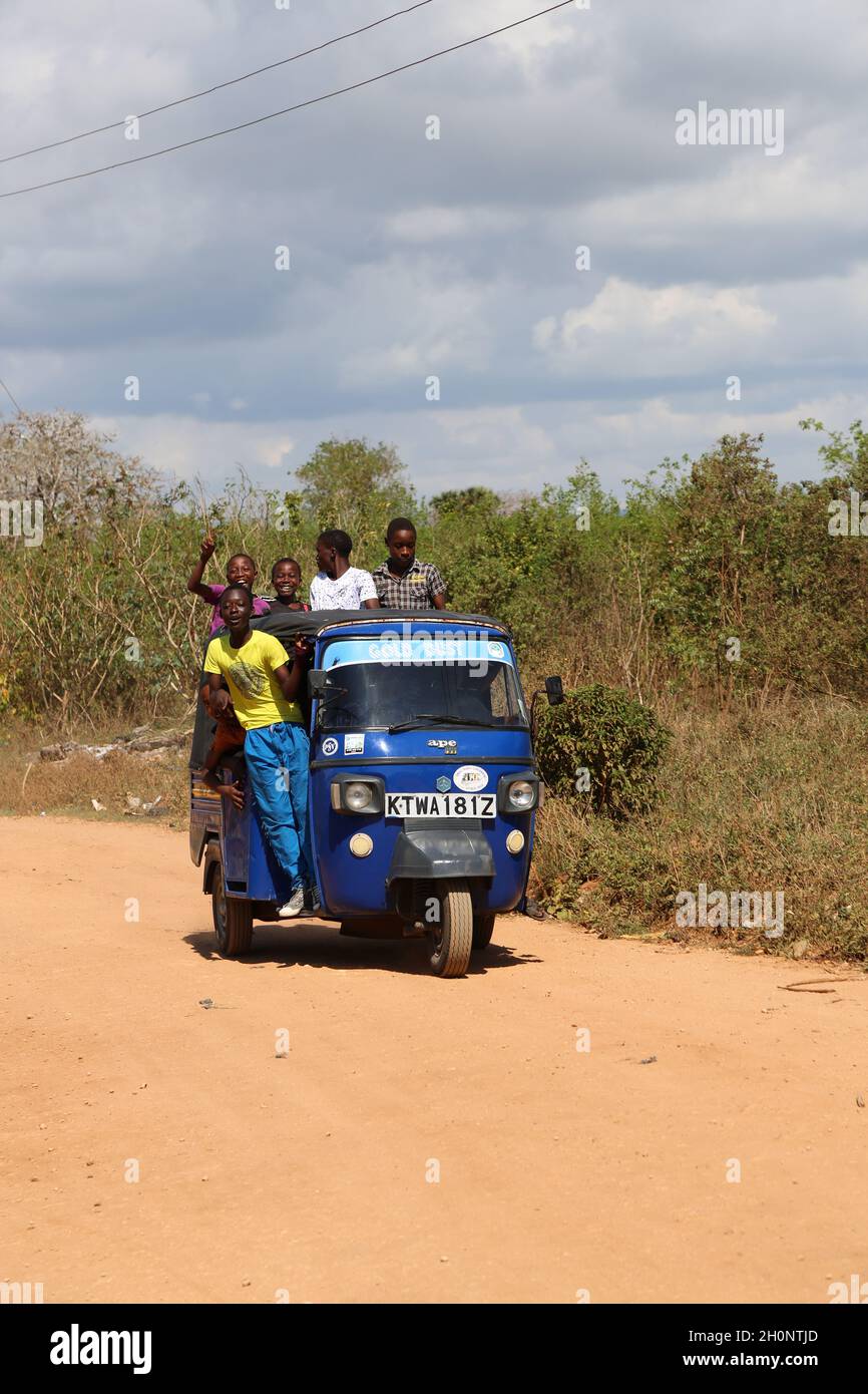 UKUNDA, KENYA - Dec 08, 2016: A view of a people riding a tuk-tuk on a ...