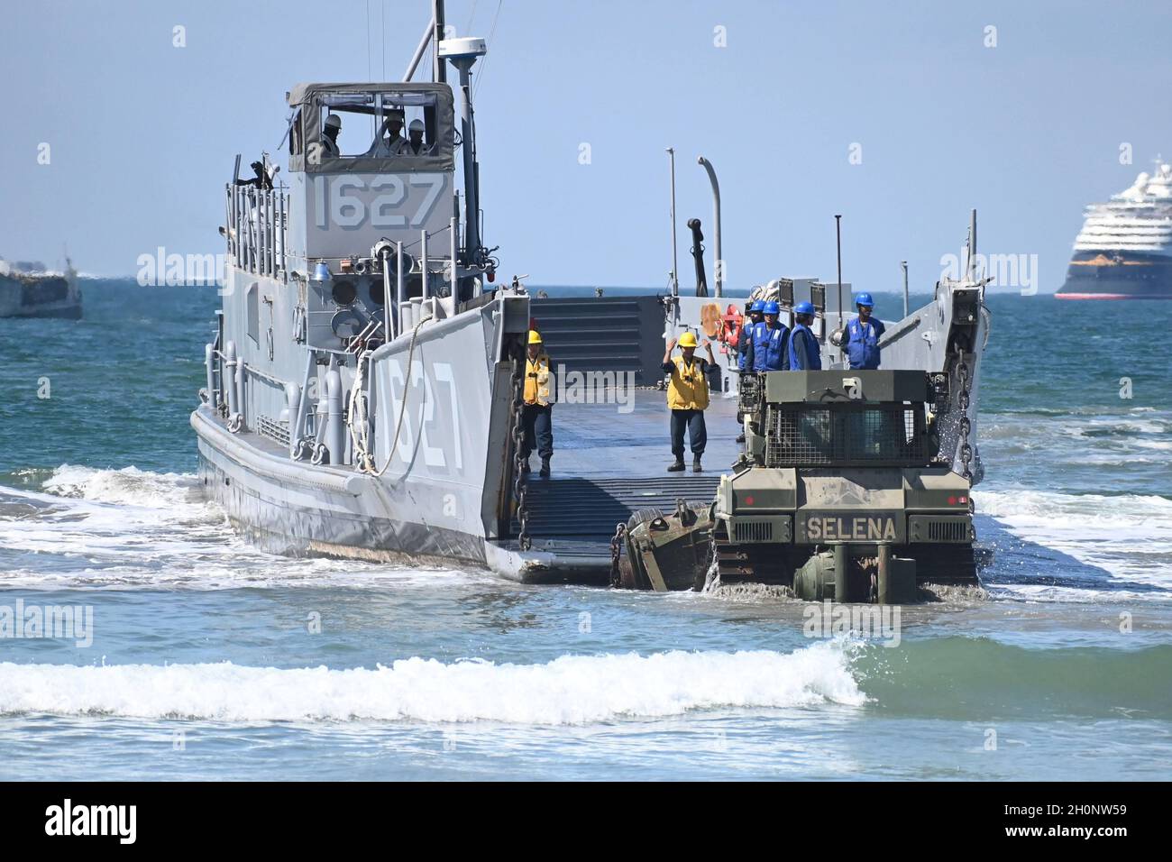 A bulldozer salvages a landing craft unit (LCU) after completing ...