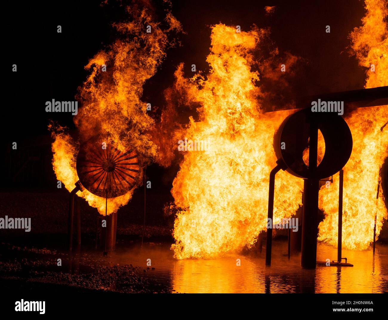 Fire engulfs the engine and wing of an aircraft fuselage mock-up Oct. 5 ...